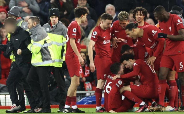 Teenager arrested after 'unacceptable' pitch invasion during Liverpool ...
